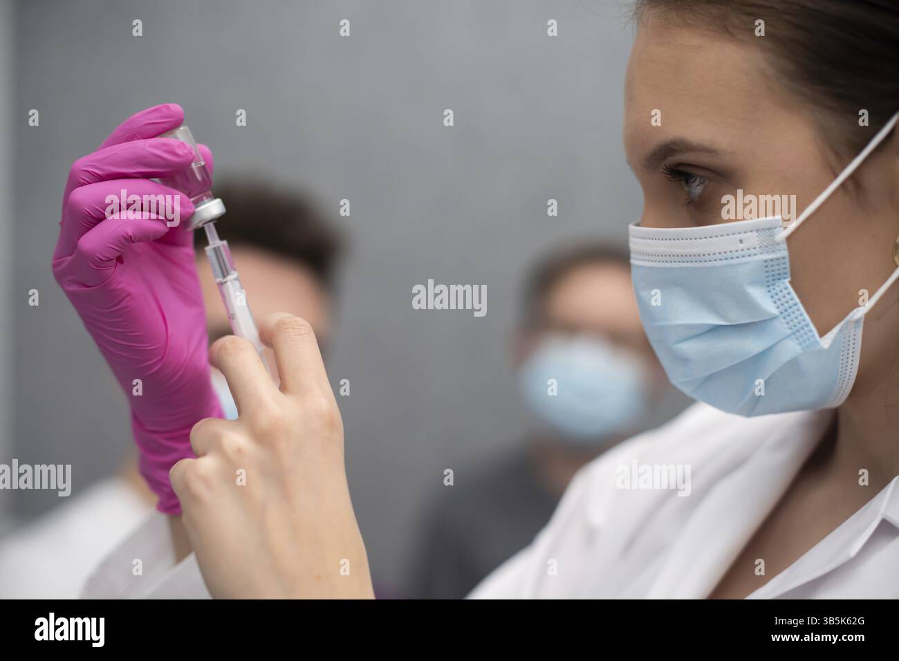 In a practical lesson, a young nurse shows medical trainees how to ...