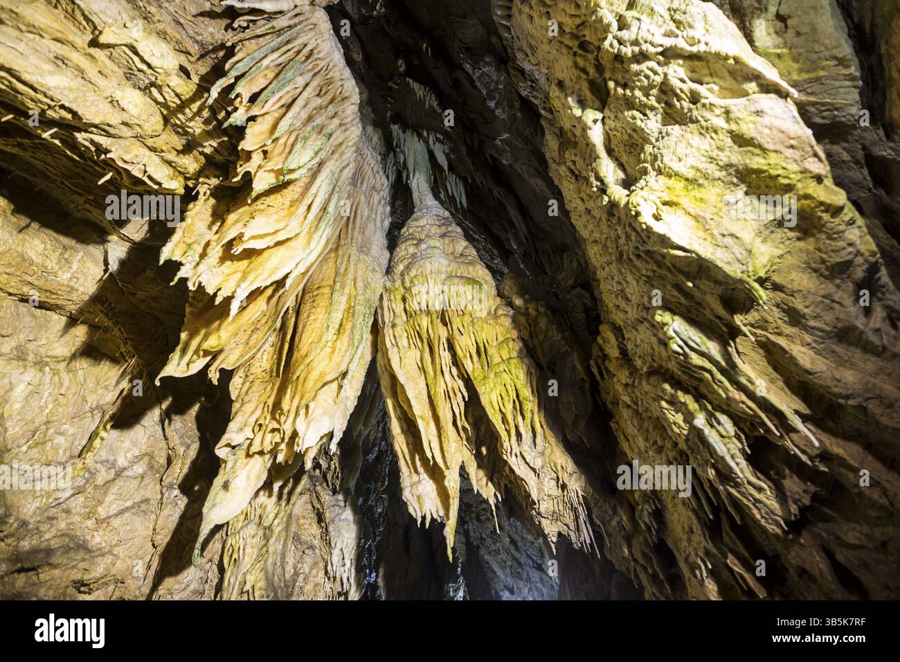 Inside of a beautiful colourful cave. Flowstones, stalactites and ...