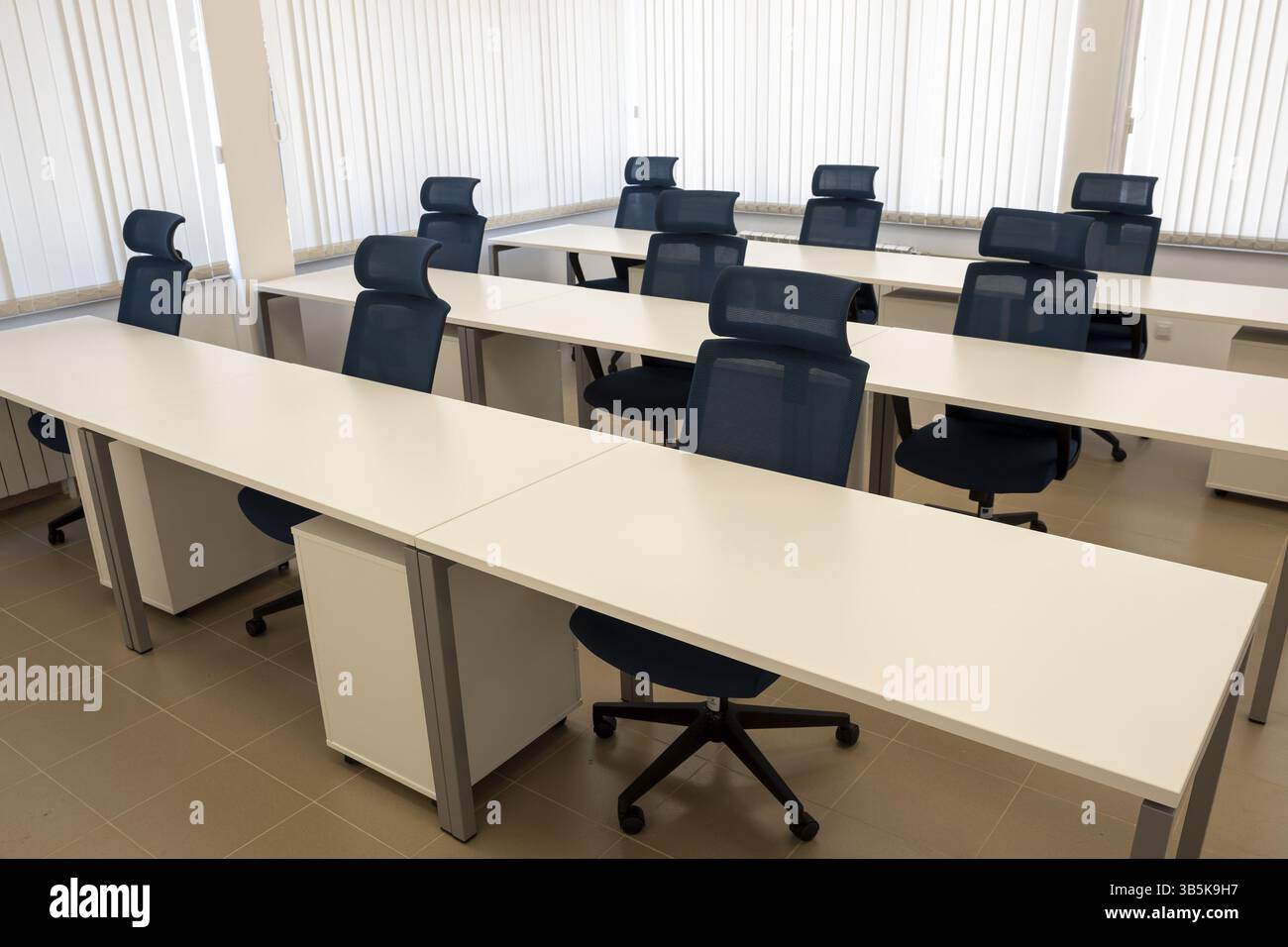 Chairs and desks are seen in a small empty conference room Stock Photo ...