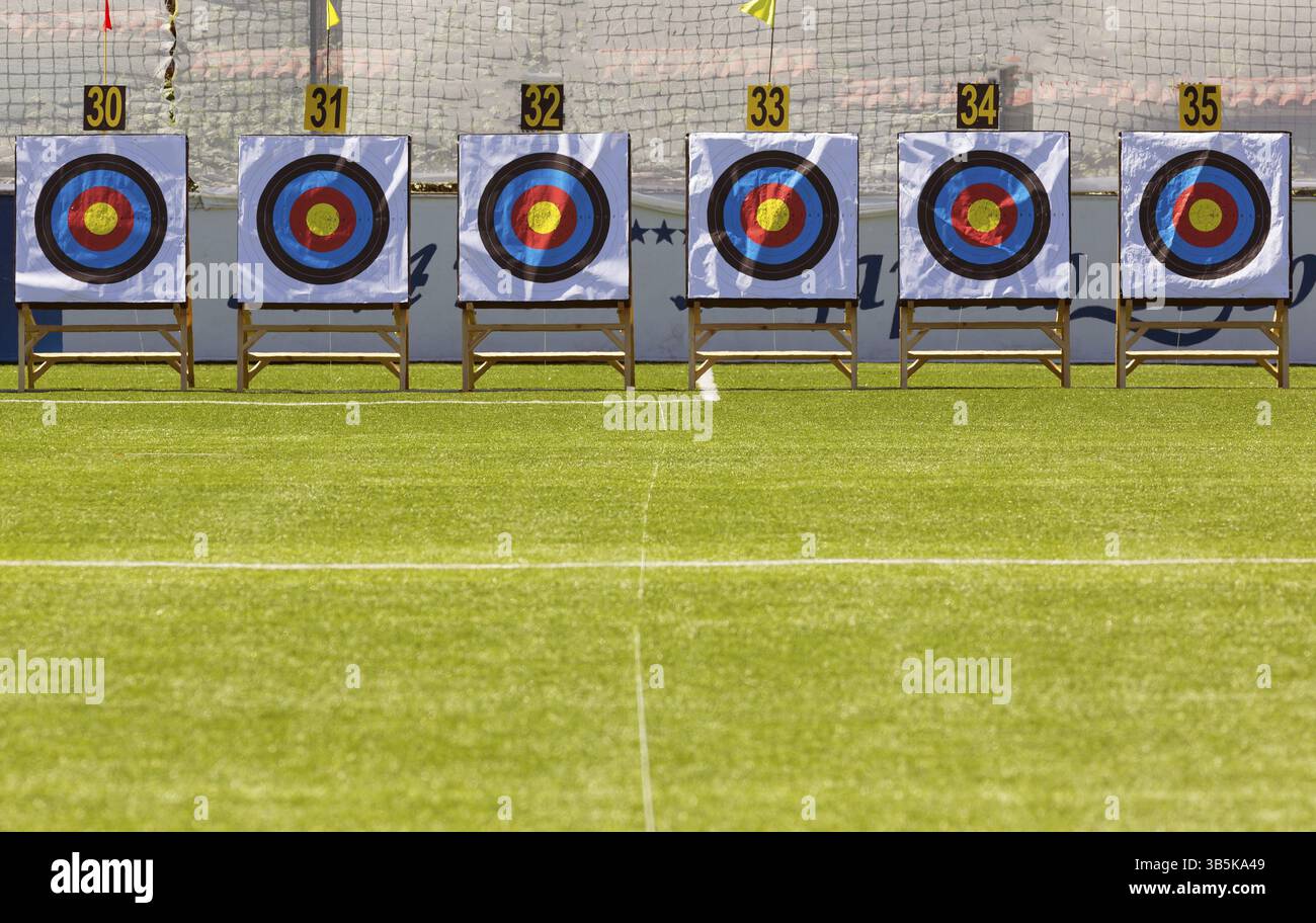 Six archery target rings during an archery competition. Green grass ...