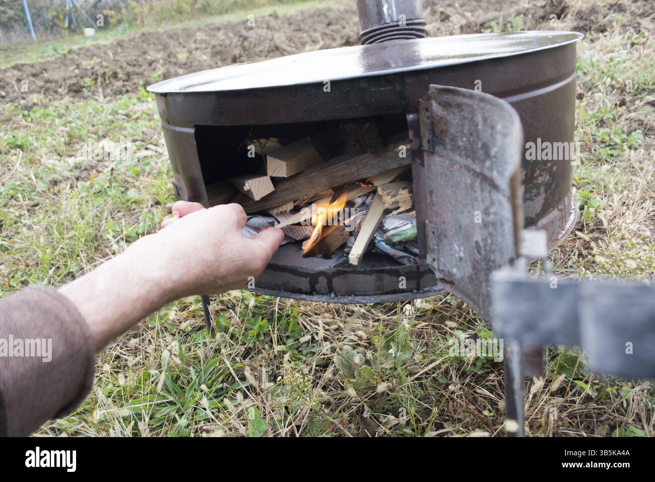 Setting a fire into the small portable stove Stock Photo - Alamy