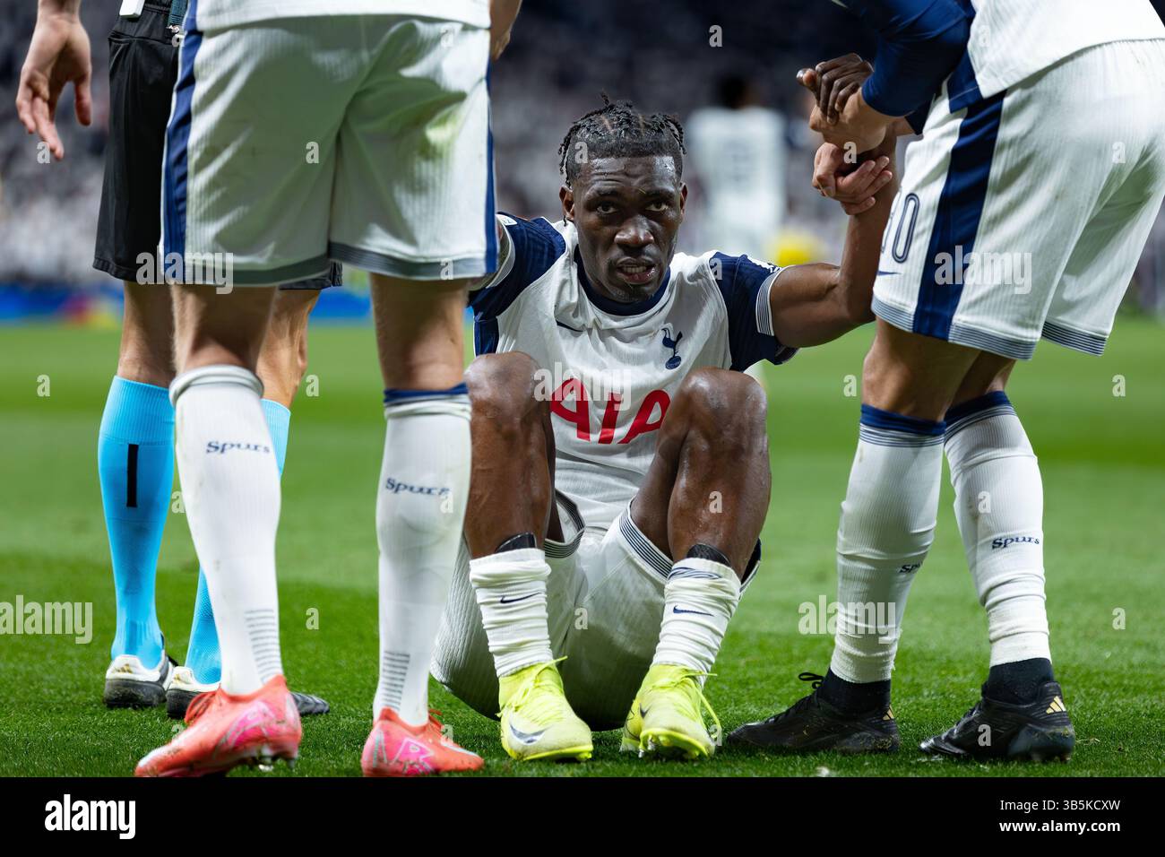 Yves Bissouma (8) of Tottenham Hotspur is helped up off the ground ...