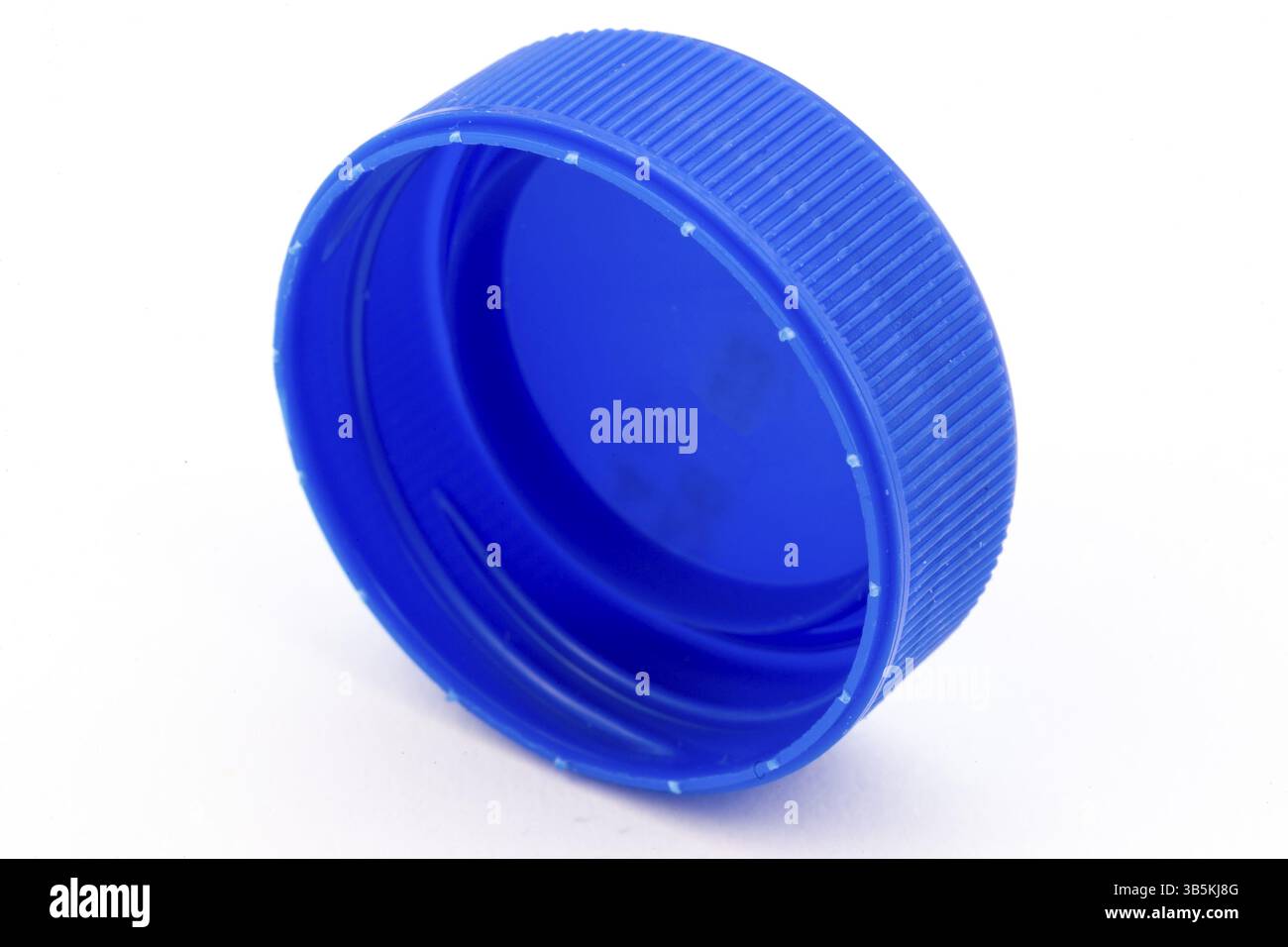 Blue plastic bottle cap. Studio shot. Plastic waste. Isolated on a ...