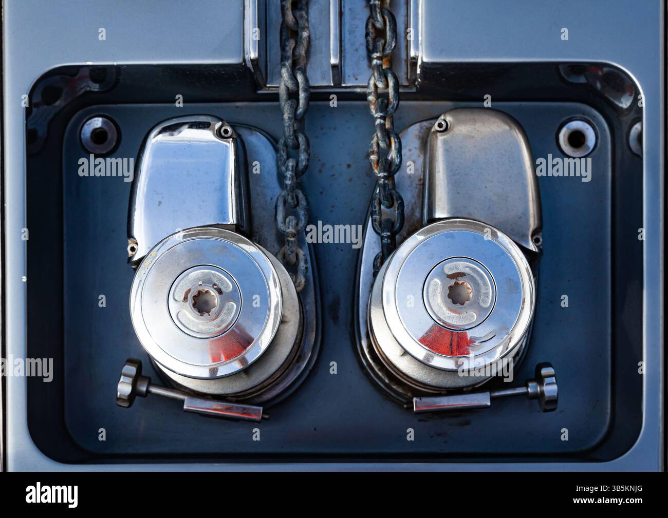 Anchor winches with part of the anchor chain on the deck of a luxury ...