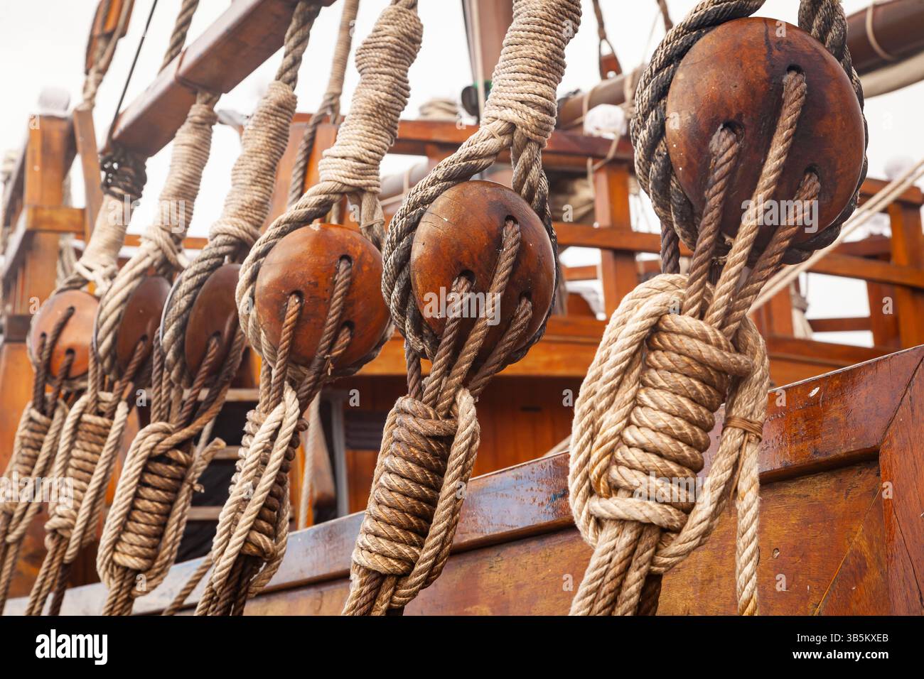 Traditional wooden sailing ship. Part of an old wooden ship with ropes ...