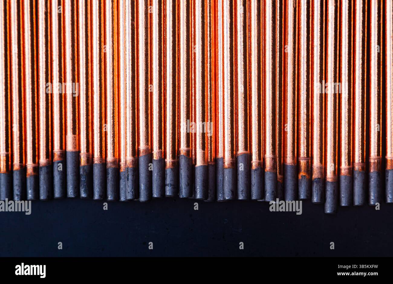 Background of round graphite gouging electrodes stacked vertically ...