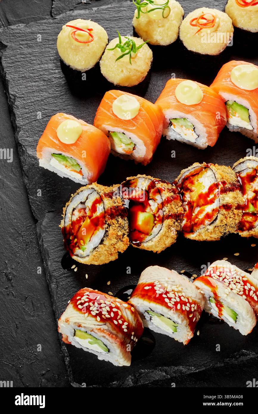 Variety of sushi rolls with different toppings and fillings, creating ...