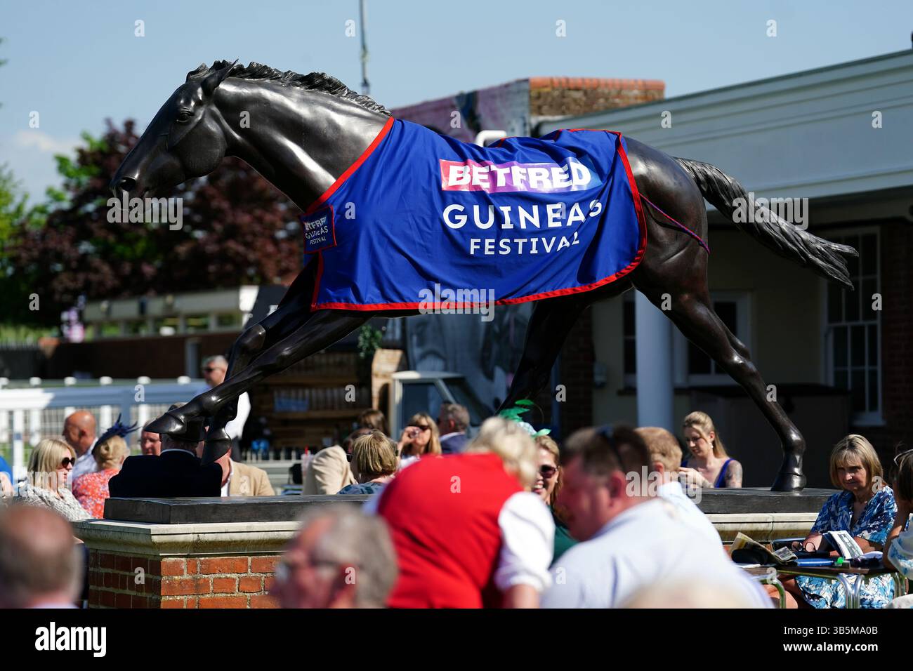 A bronze statue of Persian Punch draped in a Betfred Guineas Festival ...