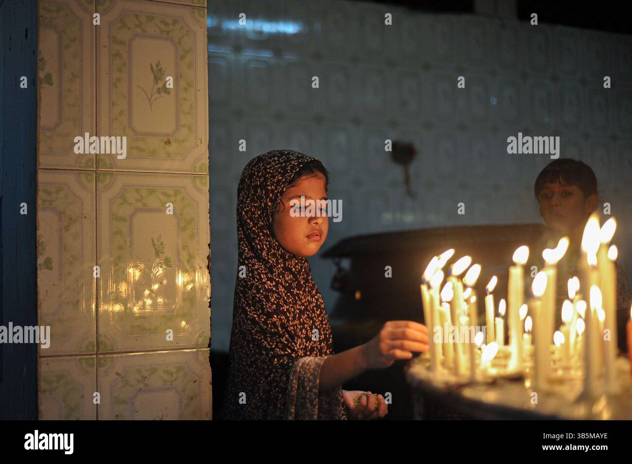 August 5, 2022: Sylhet, Bangladesh: Devotees are lighting the candle at ...