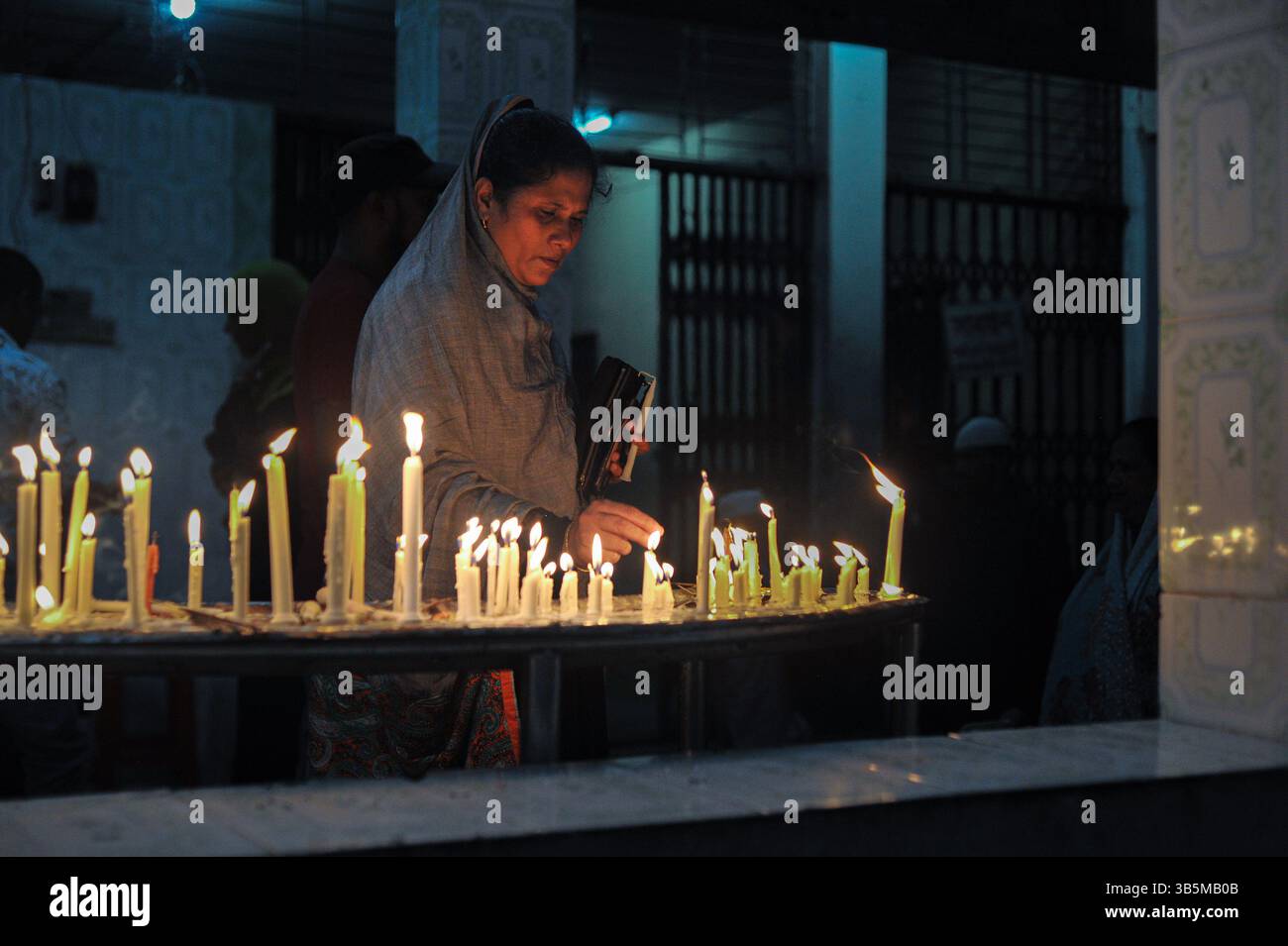 August 5, 2022: Sylhet, Bangladesh: Devotees are lighting the candle at ...