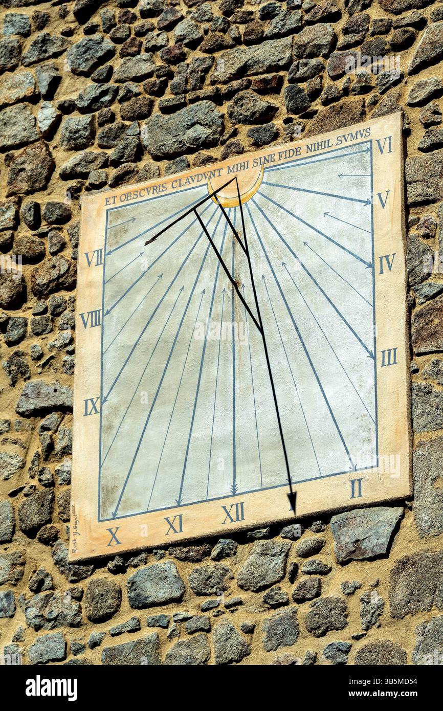 A sundial is prominently displayed on a stone wall, casting shadows on ...