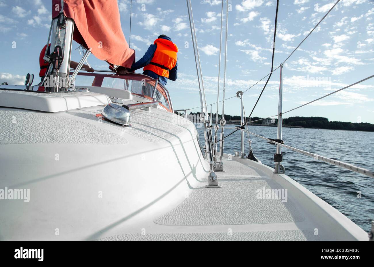 Deck of a sailing yacht. Person on the boat wearing a life jacket Stock ...
