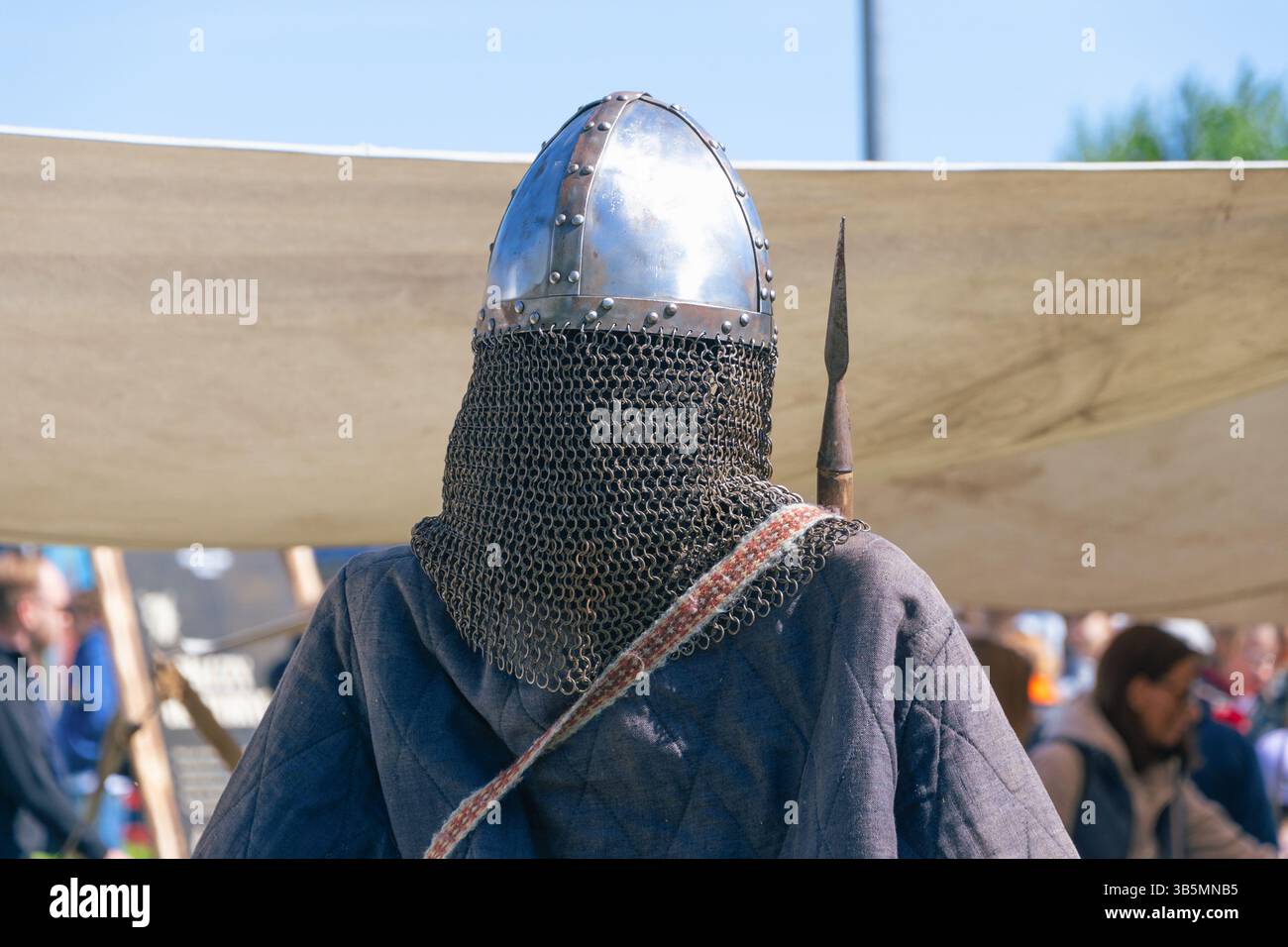 Medieval reenactment scene with armed knight in chainmail and helmet ...