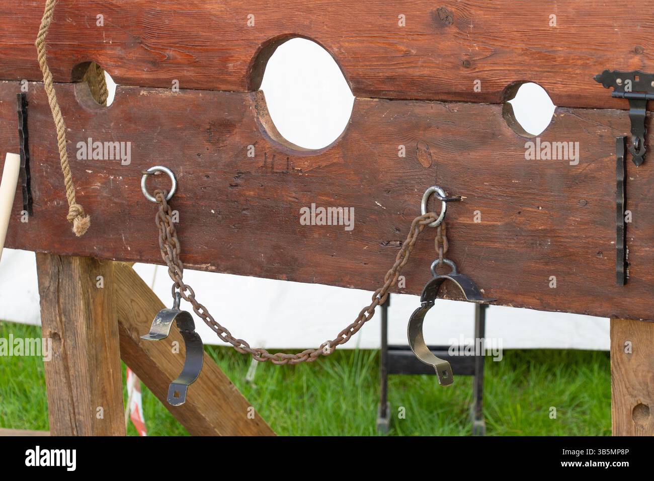 Rustic wooden stockade with metal shackles for historical medieval ...