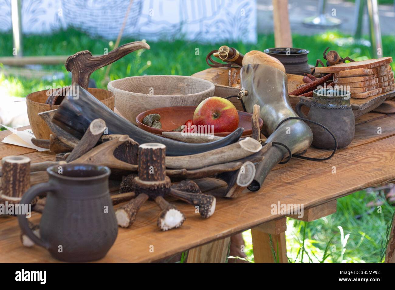Rustic medieval feast table with antlers and drinking horns Stock Photo ...