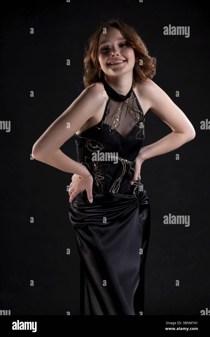 A stylish and sophisticated model, dressed in an elegant black evening ...