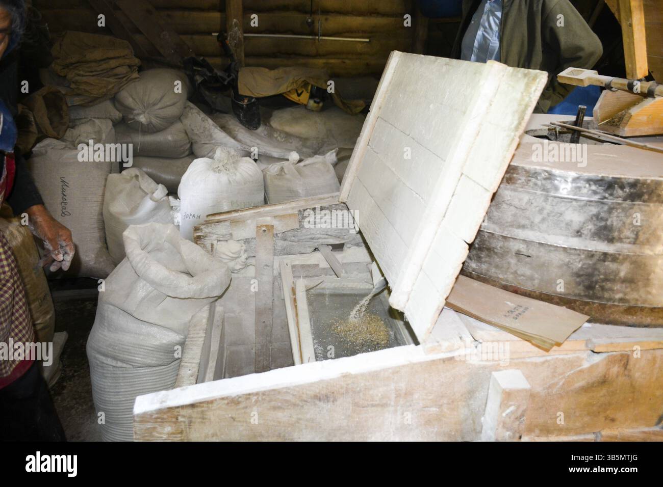 Old water mill mechanism. Millstone and grain Stock Photo - Alamy
