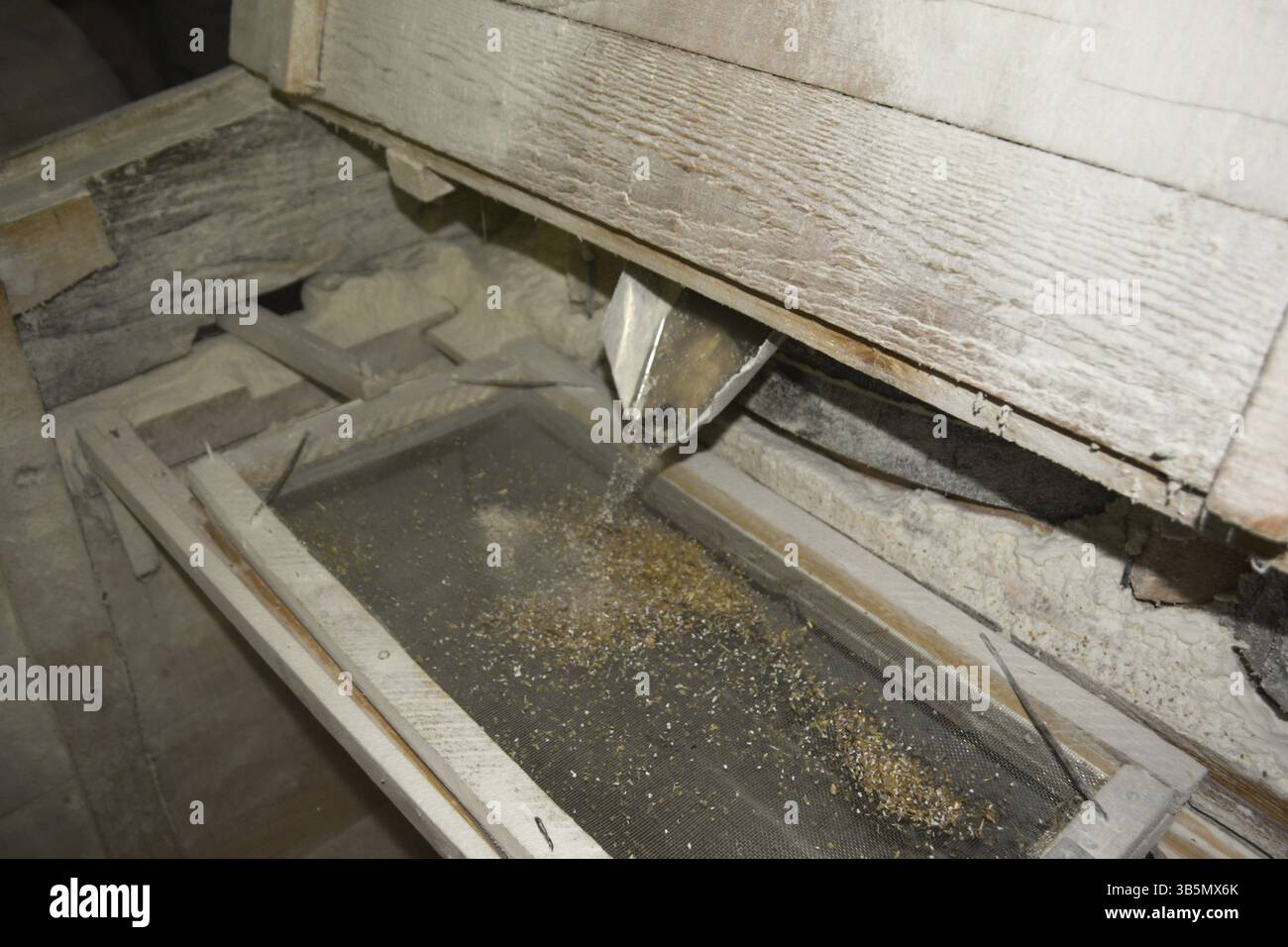 Old water mill mechanism. Millstone and grain Stock Photo - Alamy
