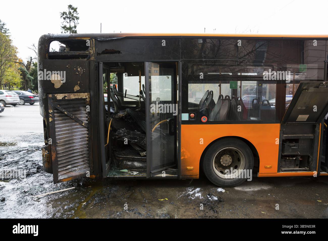 Burnt public traffic bus is seen on the street after caught in fire ...