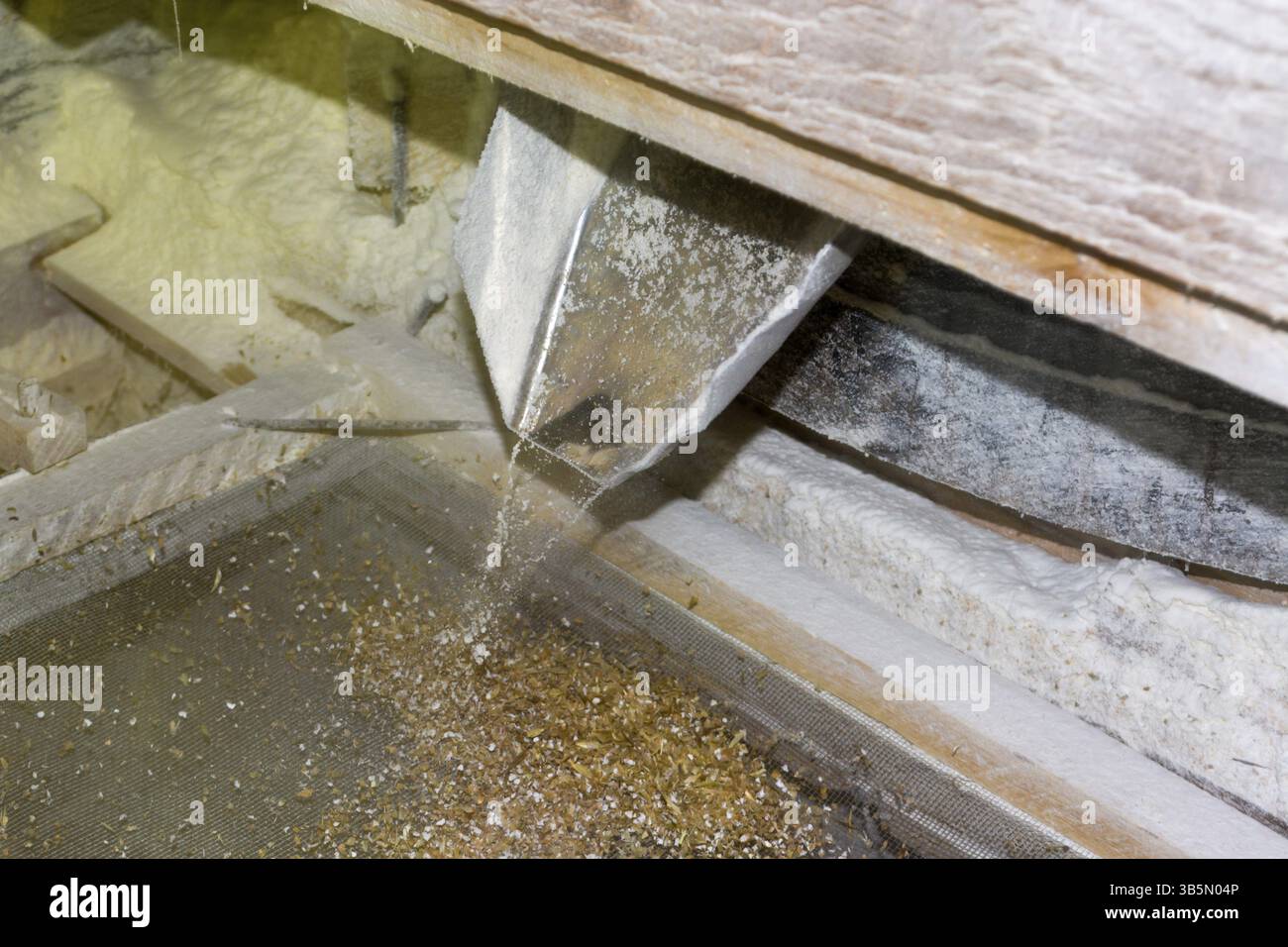 Old water mill mechanism. Millstone and grain Stock Photo - Alamy