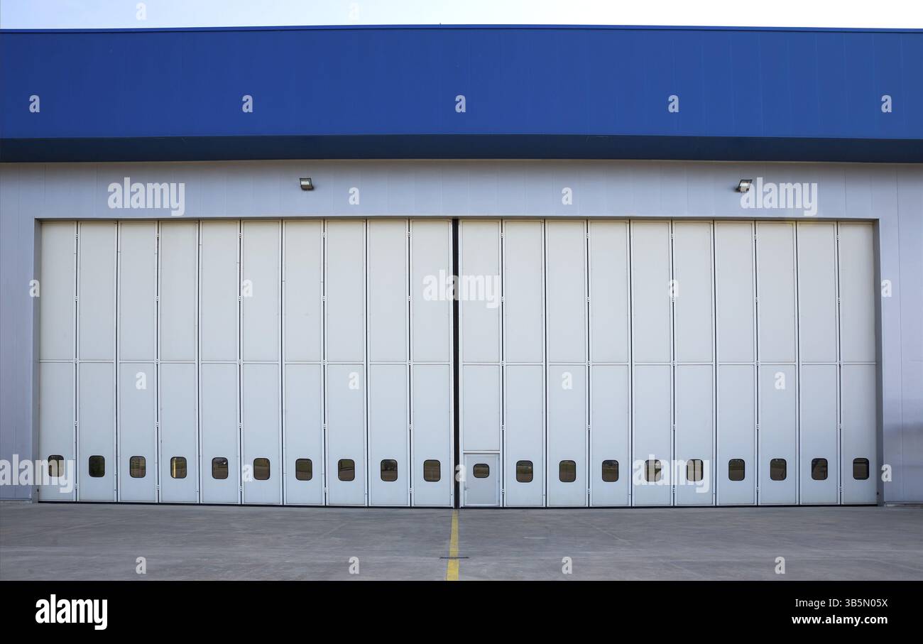 Airport hangar from the outside with big tall doors. Front view Stock ...