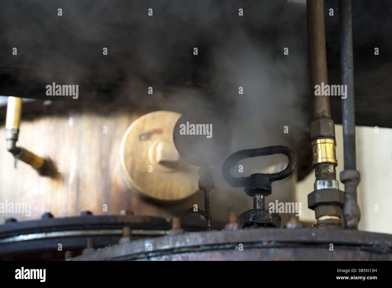 Whiskey whiskey and brandy distillery. View of a valve with steam of ...