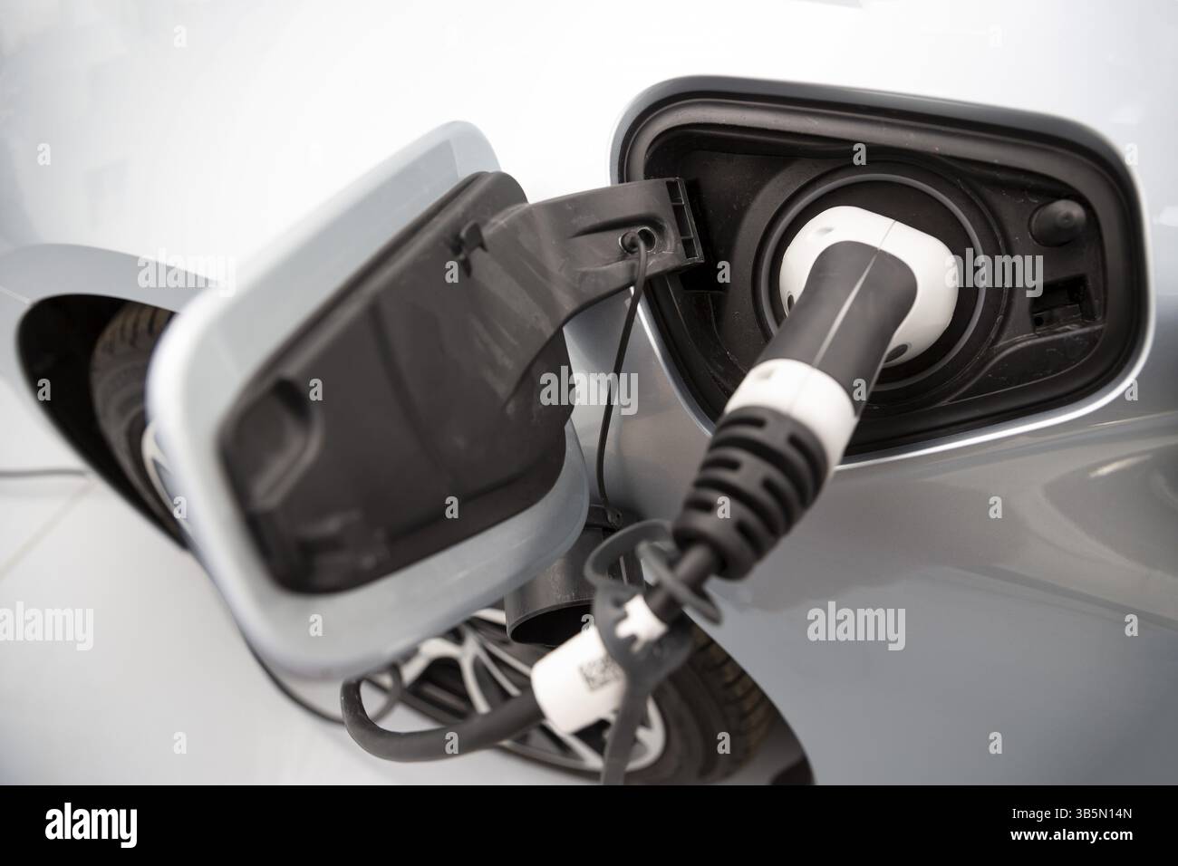 Electric car charger plugged in an electric vehicle Stock Photo - Alamy