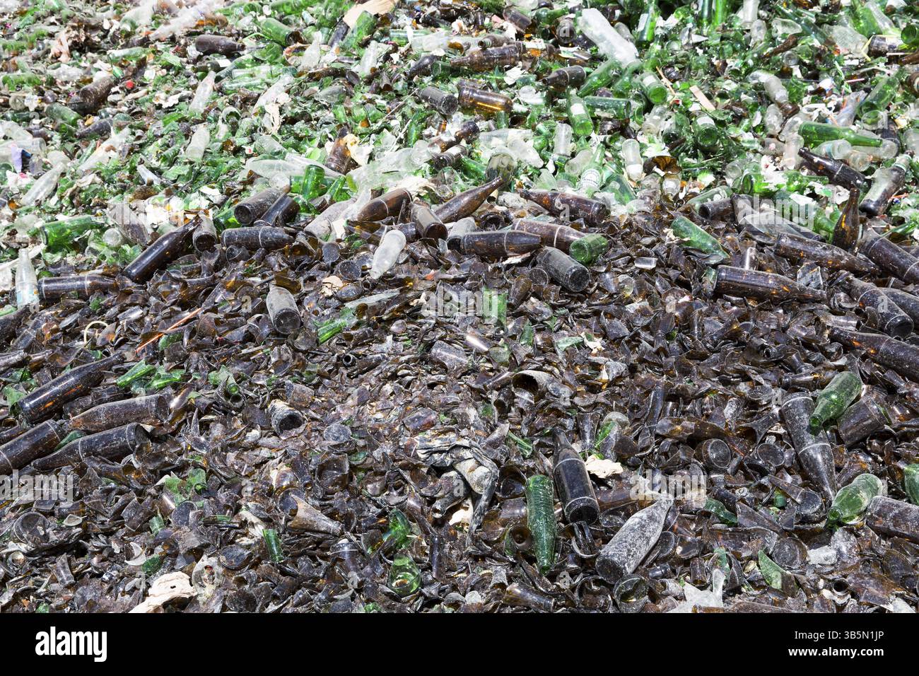Glass waste for recycling in a recycling facility. Different glass ...