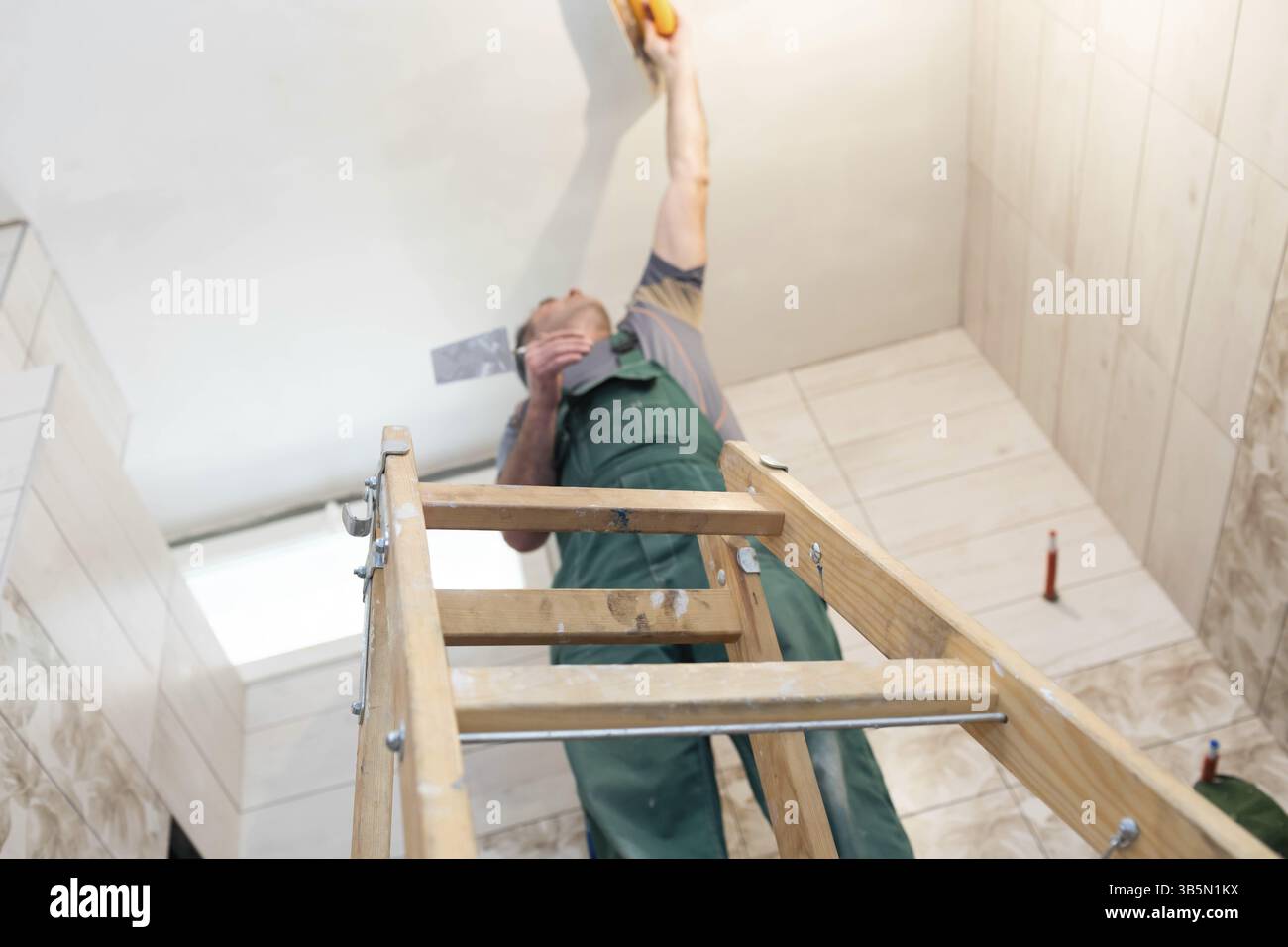Contractor in protective gear applies hi-res stock photography and ...