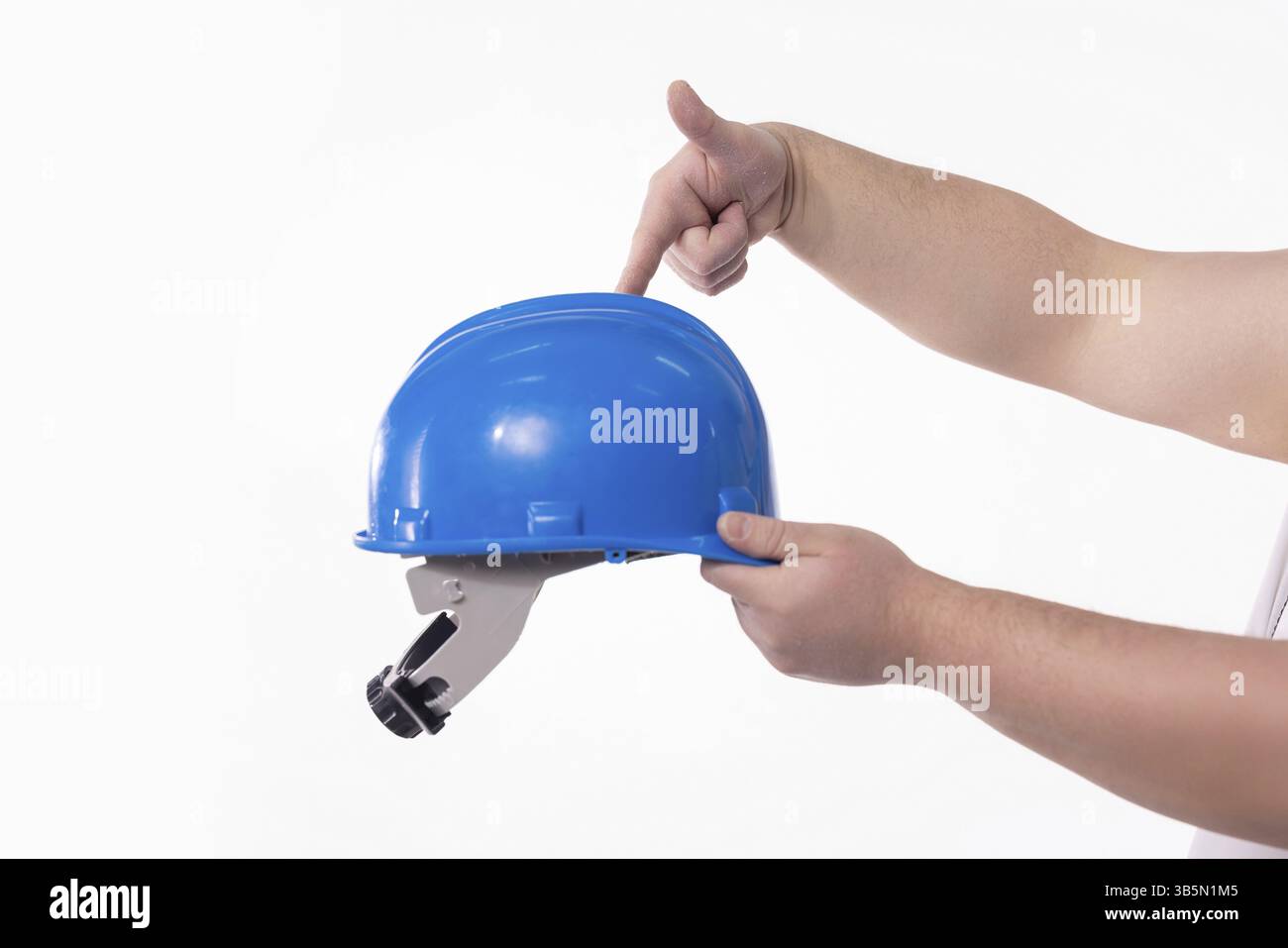 A hand firmly grasping a blue safety helmet, highlighting the crucial ...
