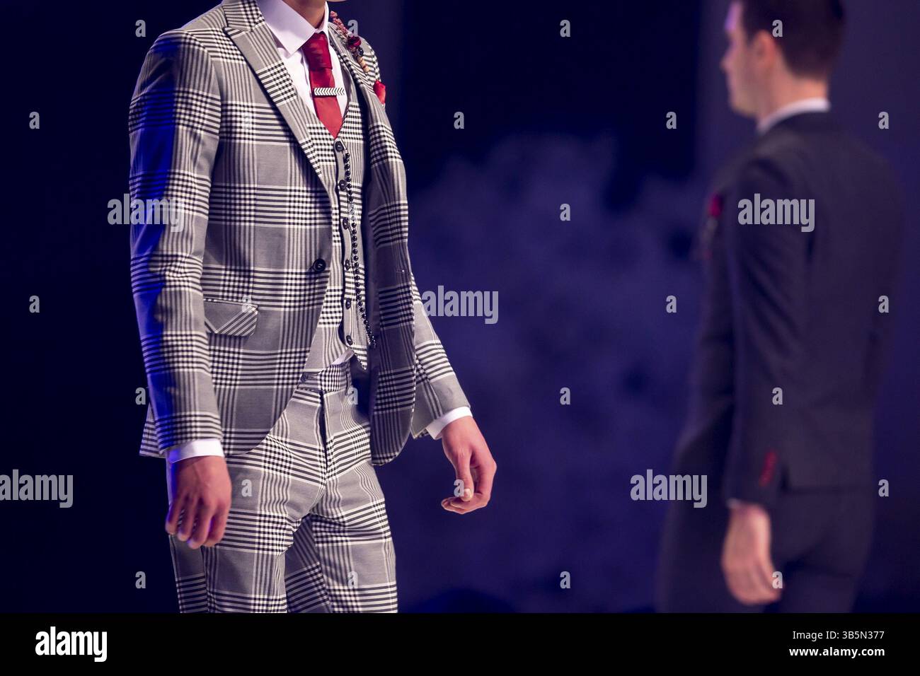 Male models walk the runway in different suits during a Fashion Show ...