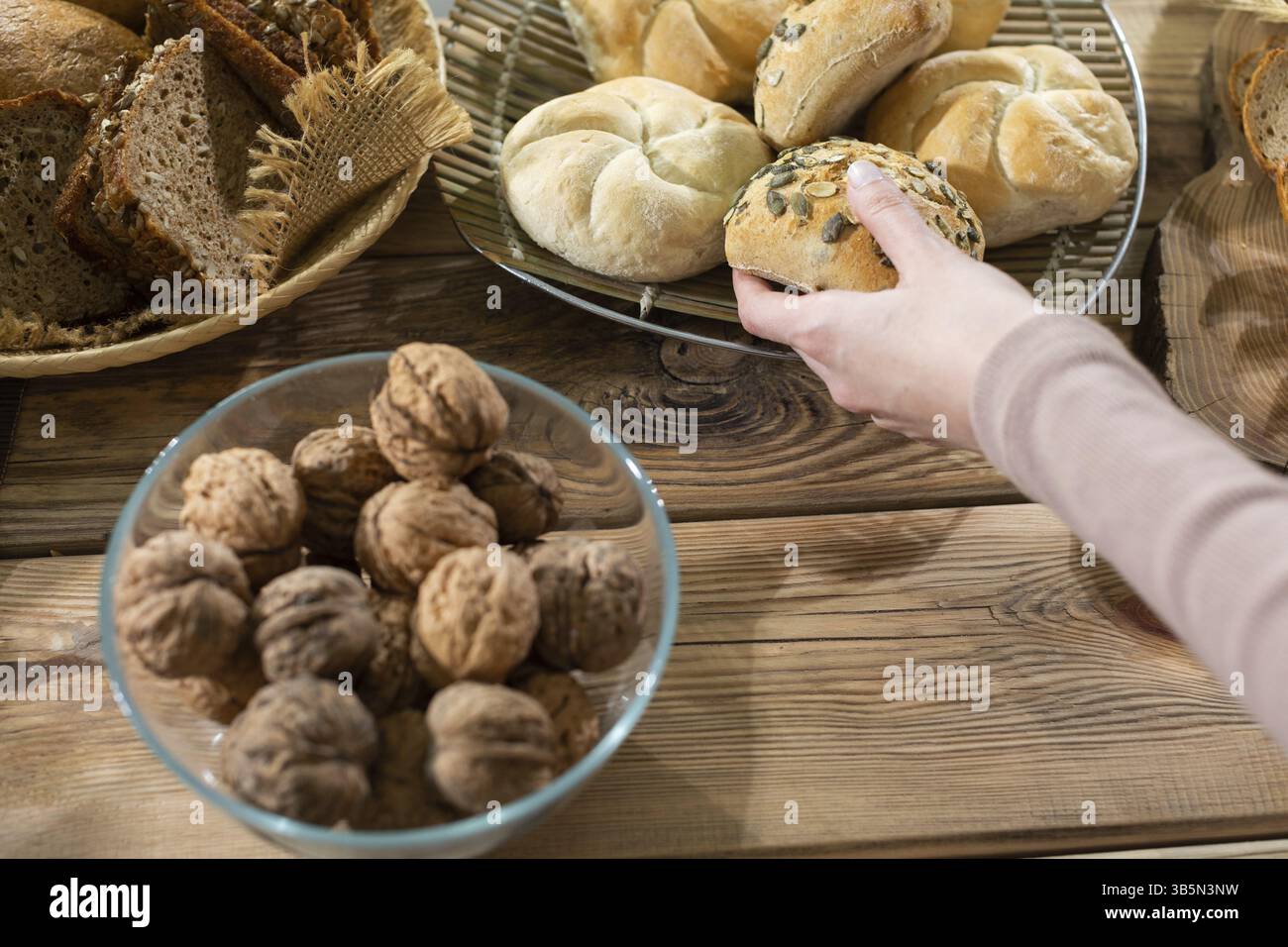 A view from above how a bakery worker gently translates individual buns ...