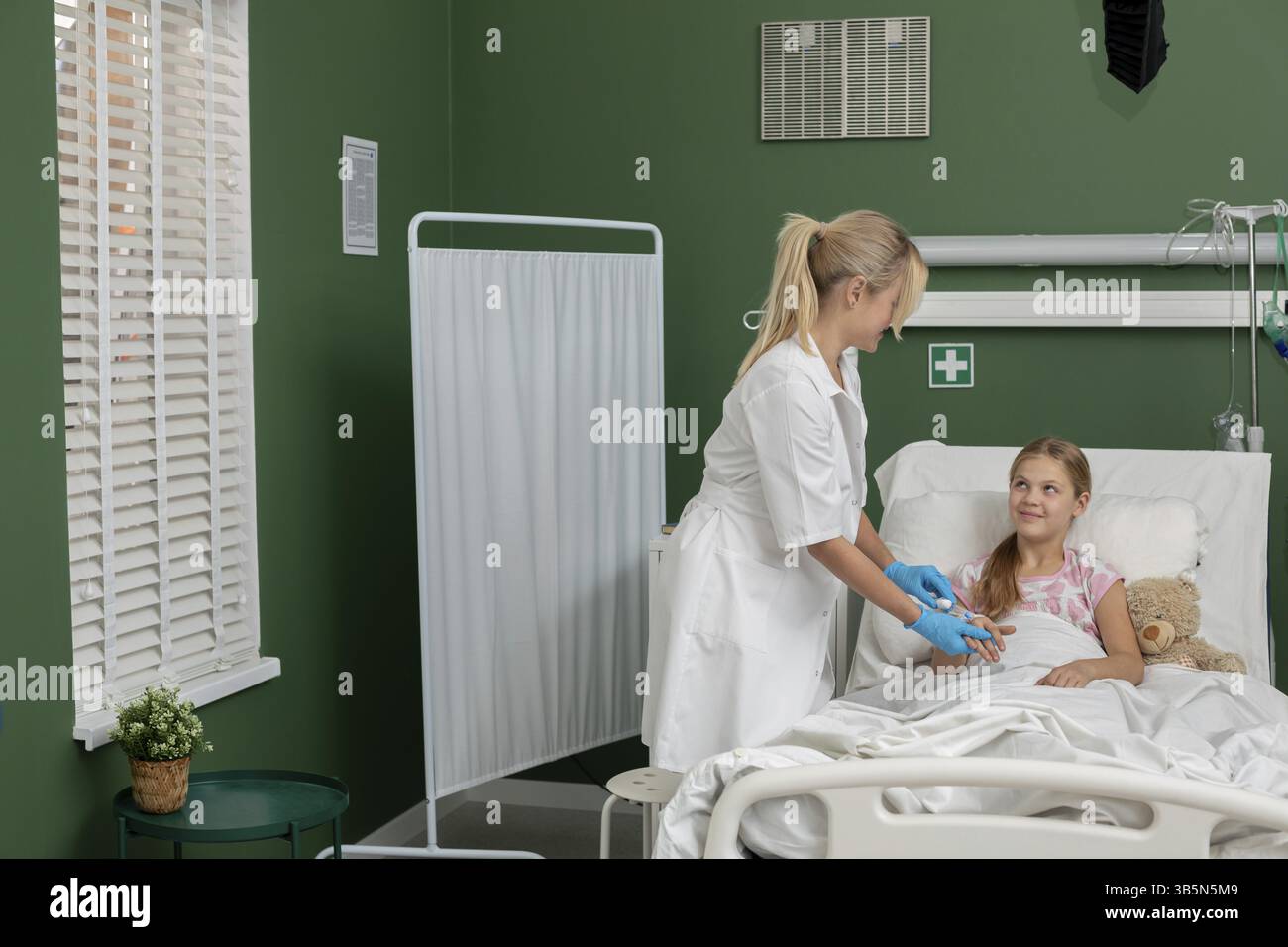 In a bright and cheerful hospital environment, a dedicated nurse ...