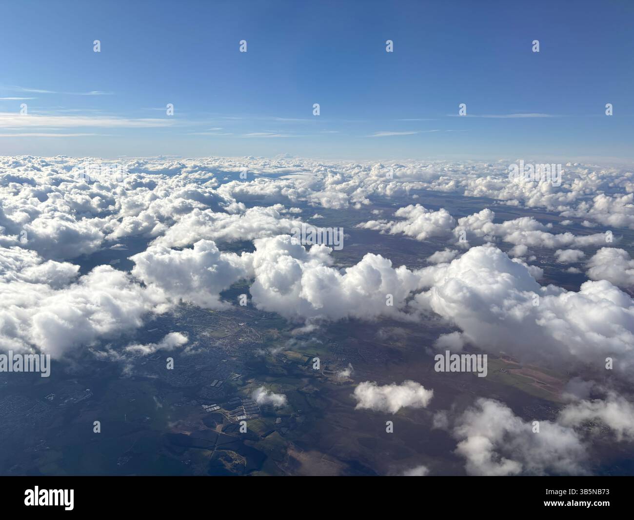 Flying high over Europe. View from aircraft window. Clouds in the sky ...