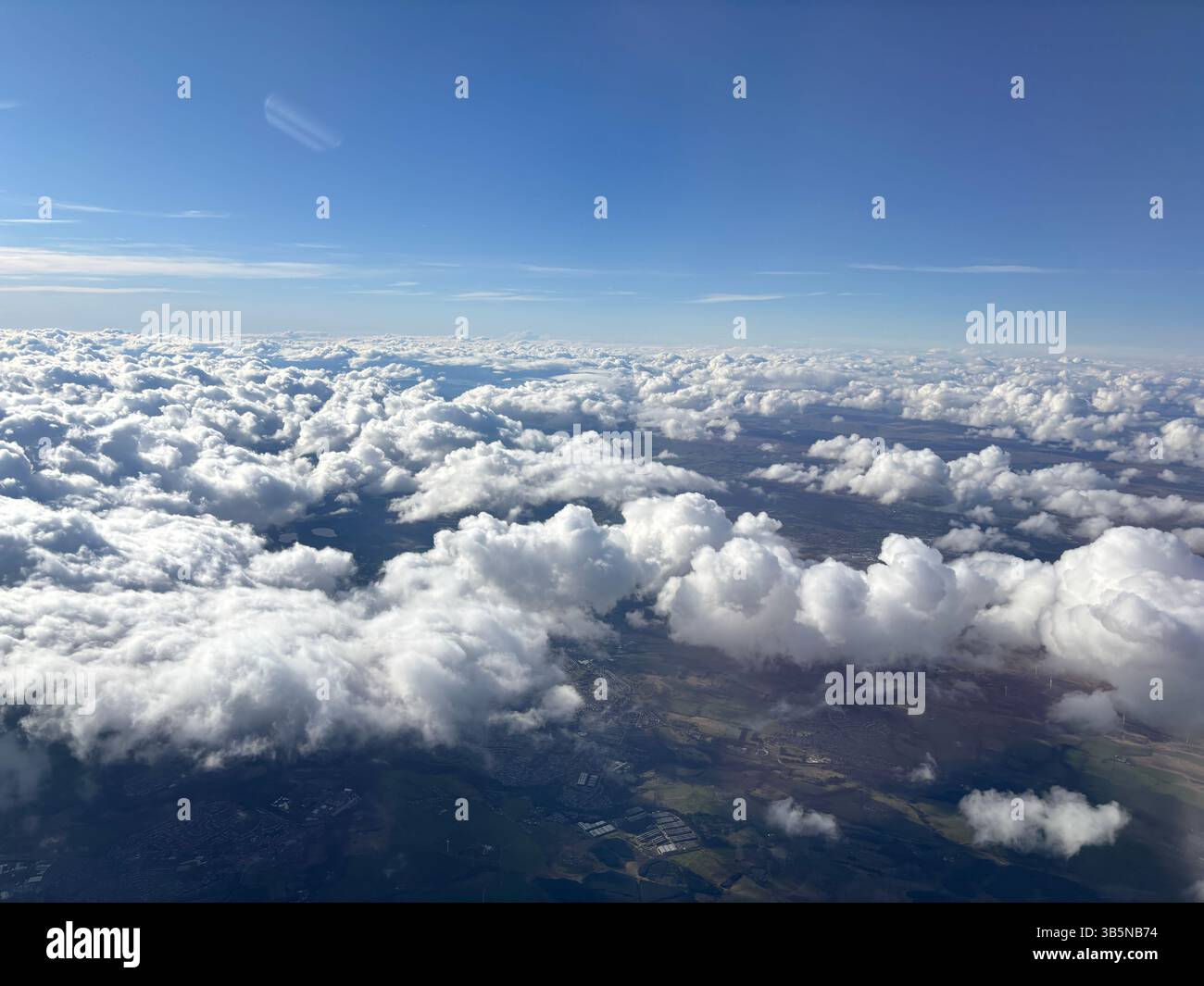 Flying high over Europe. View from aircraft window. Clouds in the sky ...