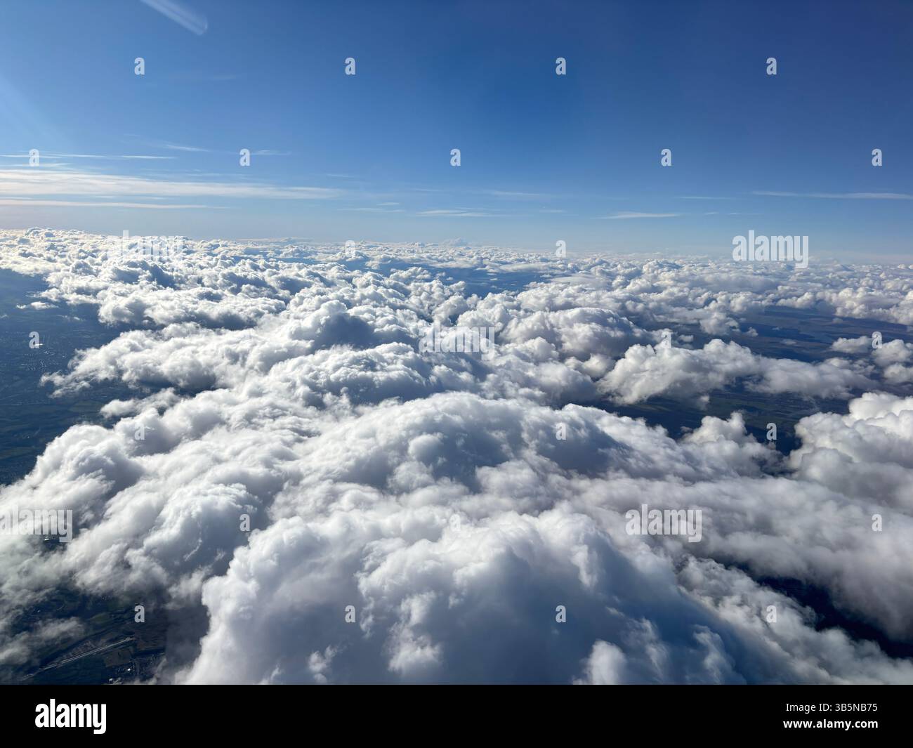 Flying high over Europe. View from aircraft window. Clouds in the sky ...