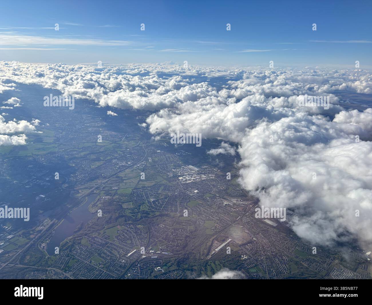 Flying high over Europe. View from aircraft window. Clouds in the sky ...