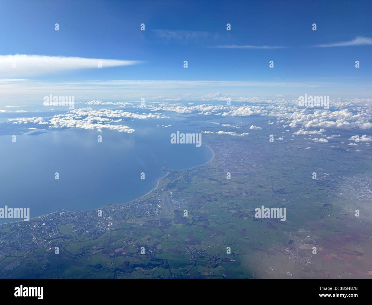 Flying high over Europe. View from aircraft window. Clouds in the sky ...