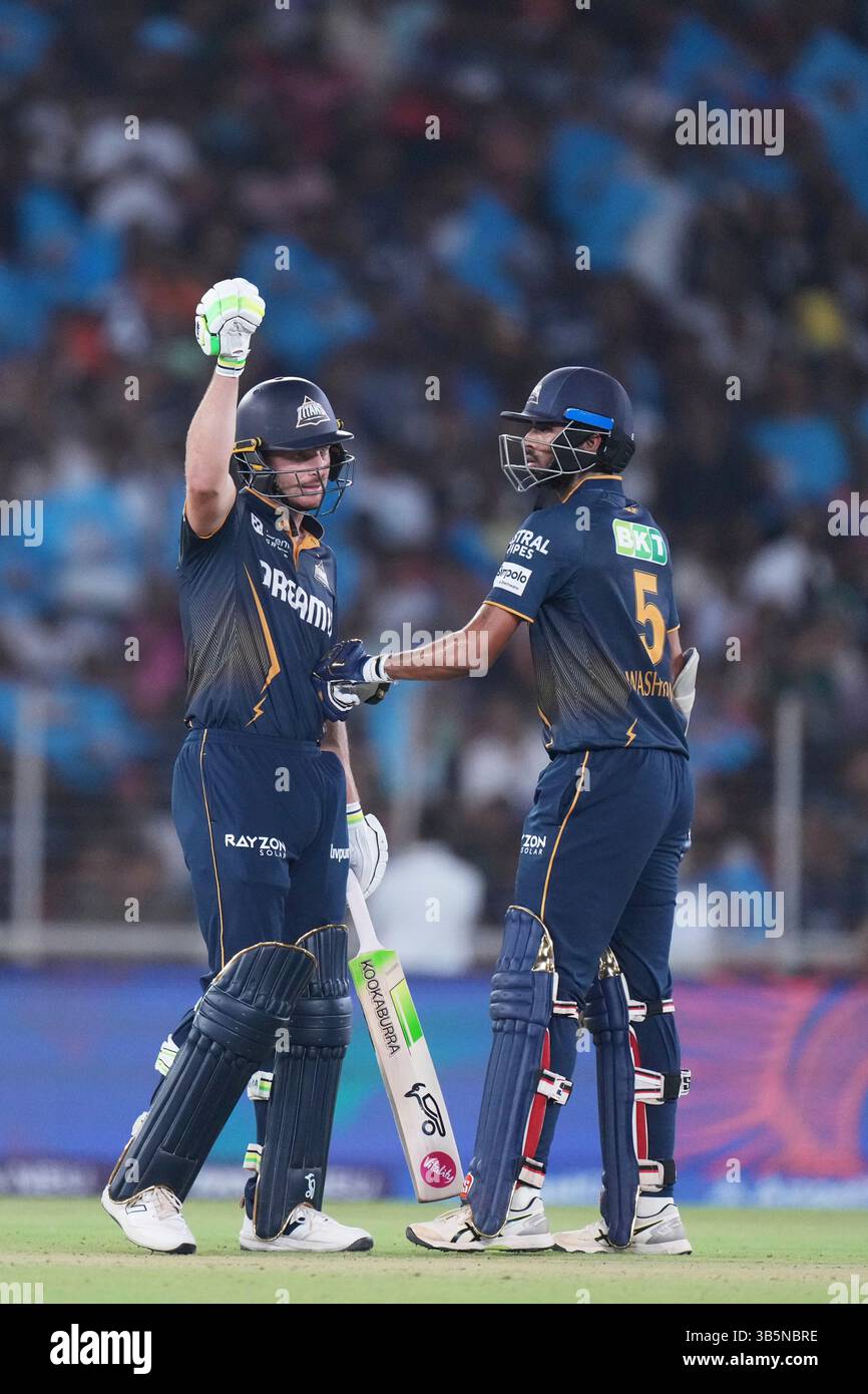 Gujarat Titans' Jos Butler, left, celebrates after scoring fifty runs ...
