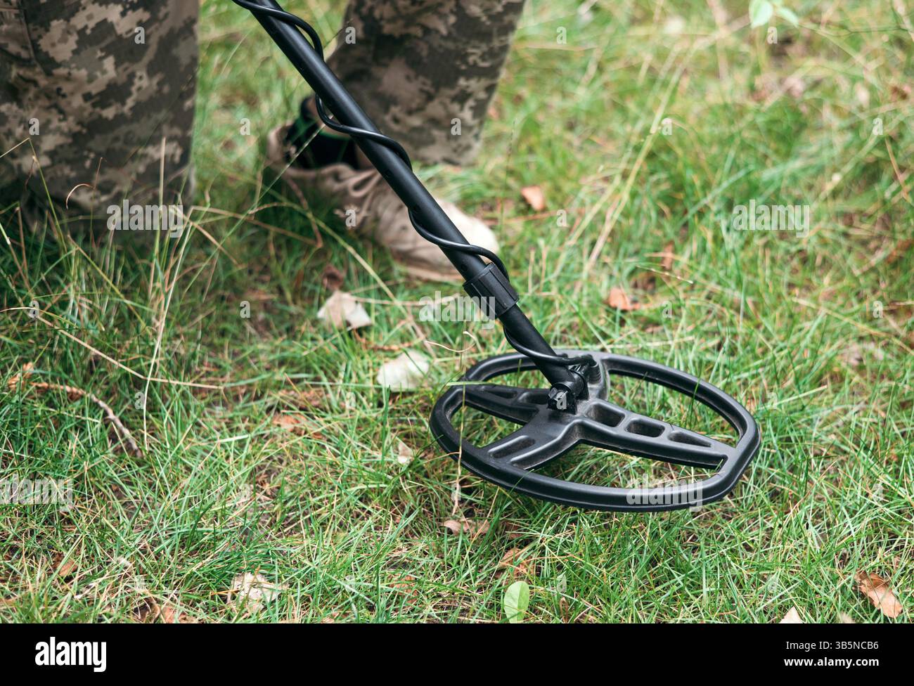 Soldier using a metal detector in fields. Ukrainian Explosive Ordnance ...