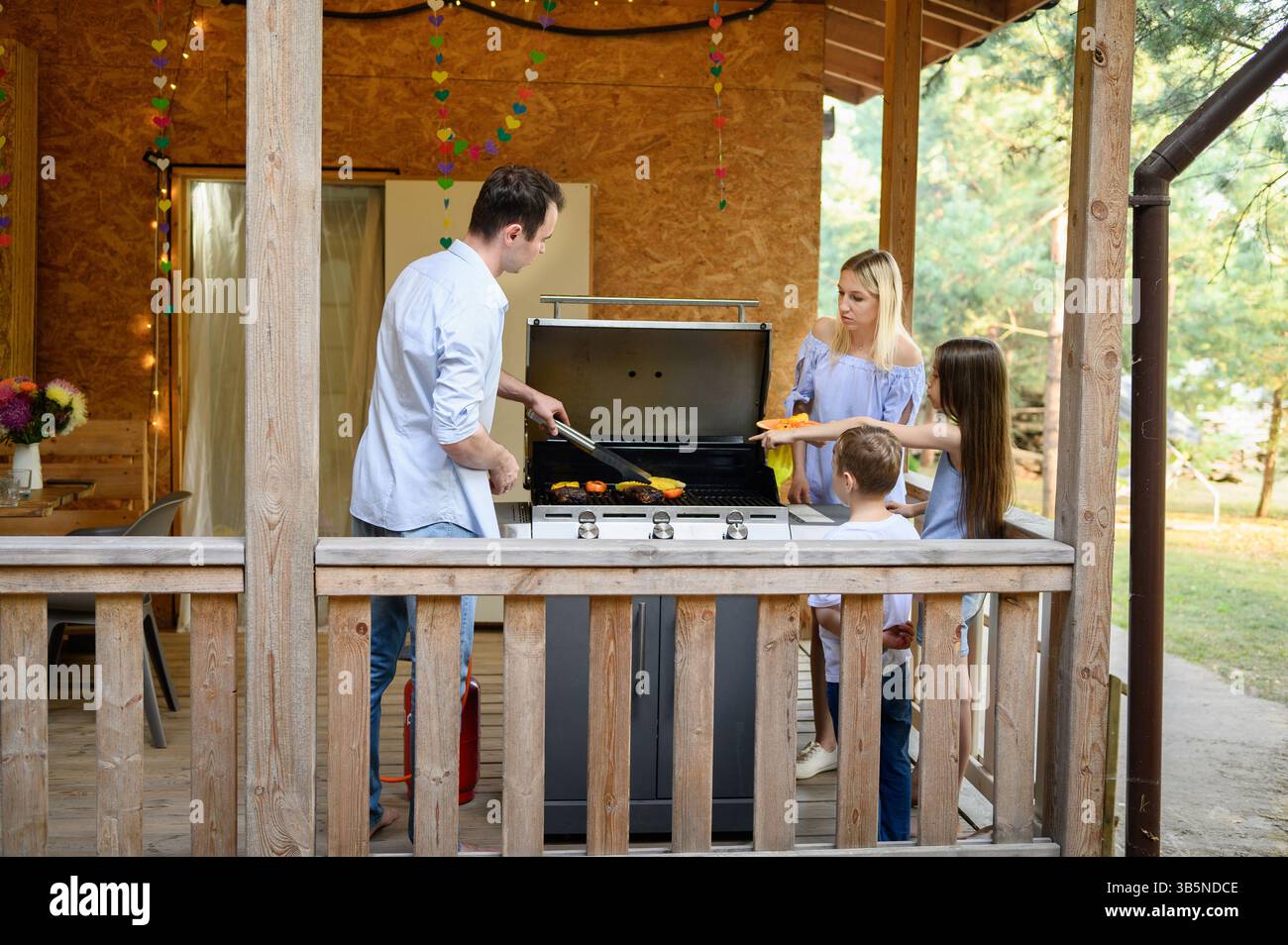 Family barbecue on veranda hi-res stock photography and images - Alamy