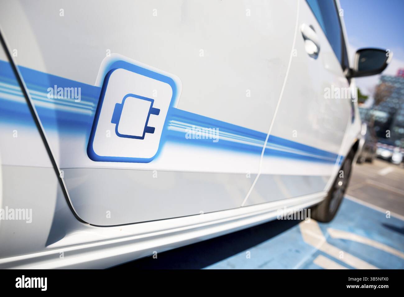 Electric Vehicle with a plug in sign on it. An electric car is an ...