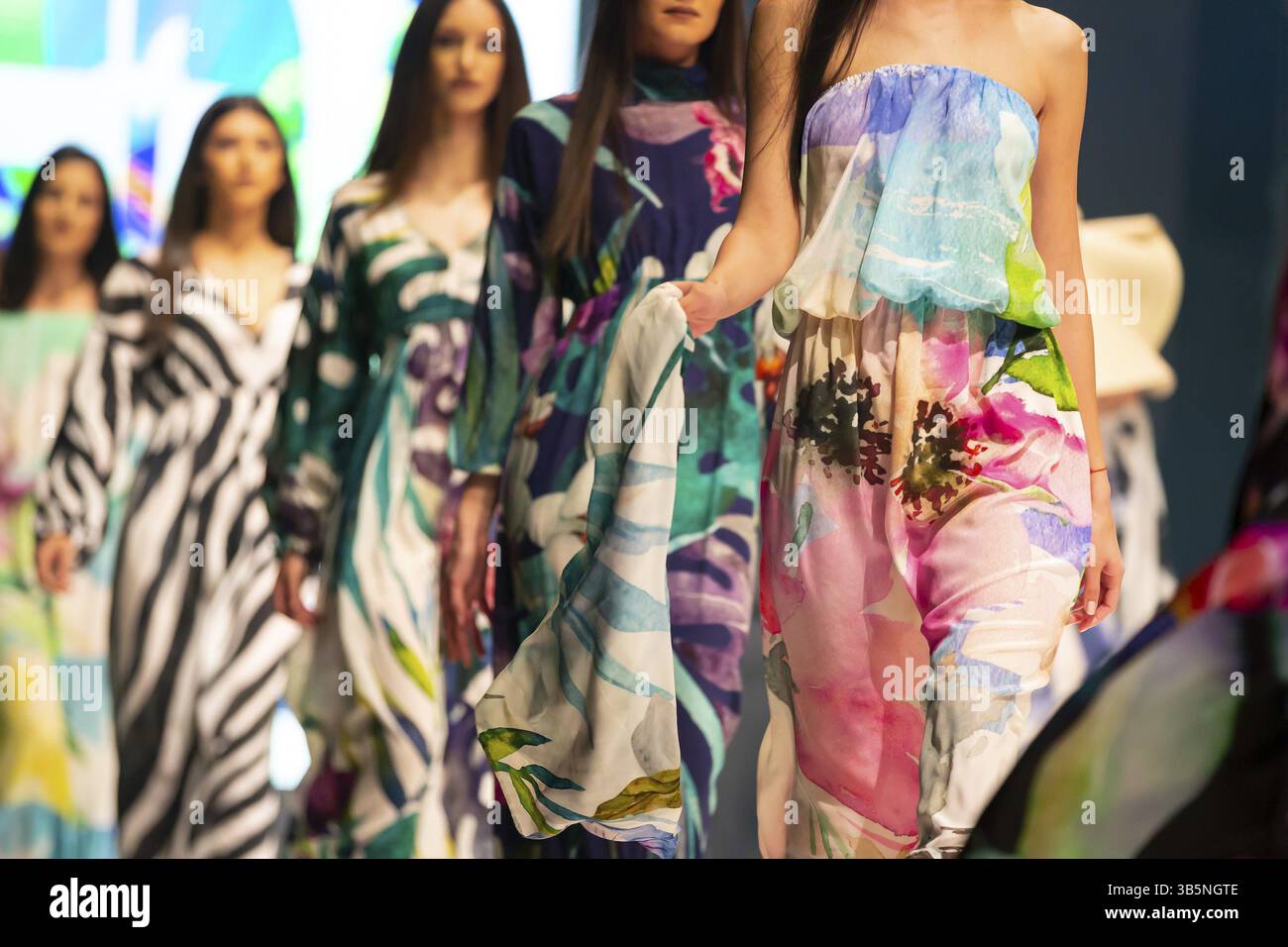 Female models walk the runway in beautiful colorful summer dresses ...
