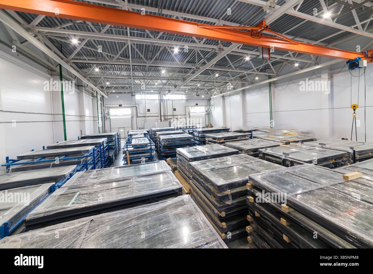 Pvc windows wrapped in stretch film, pallets and overhead crane in ...