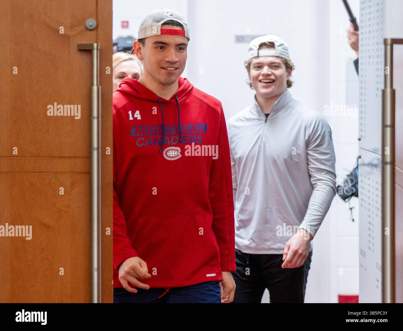 Montreal Canadiens' Nick Suzuki, left and Cole Caufield arrive for an ...
