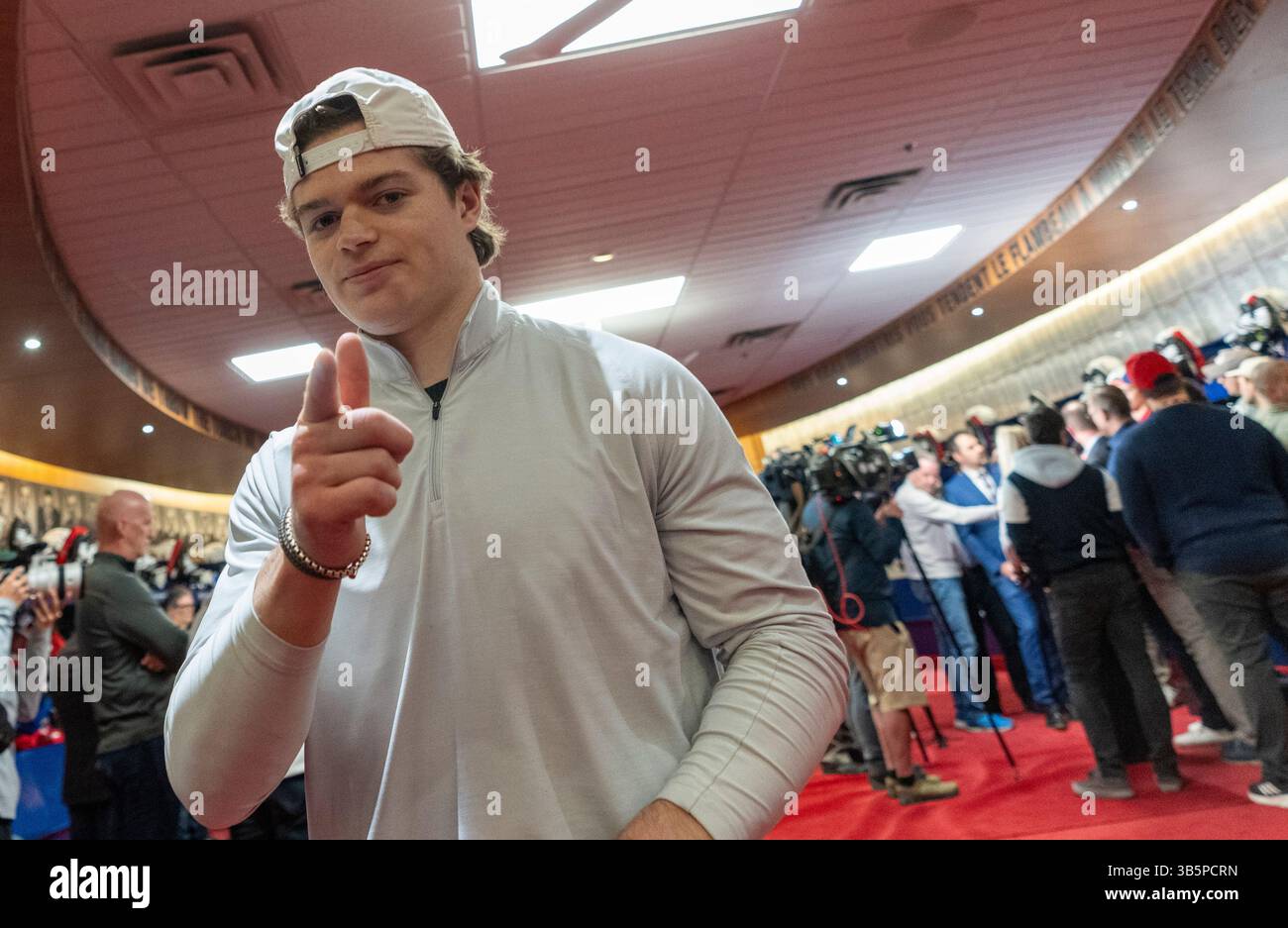 Montreal Canadiens' Cole Caufield gestures as he leaves an end of the ...