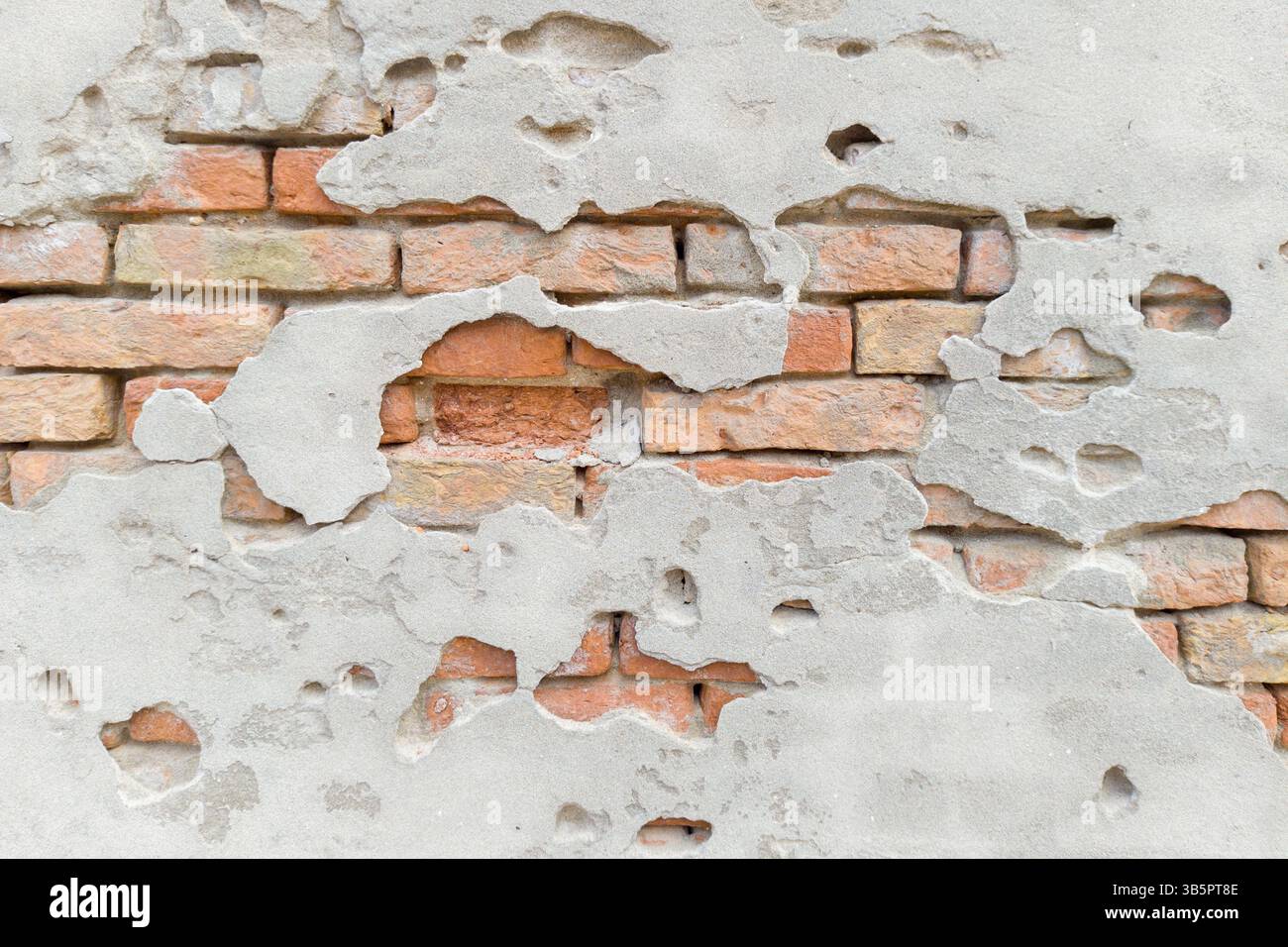 Damaged Plaster Wall Revealing Old Bricks Stock Photo - Alamy