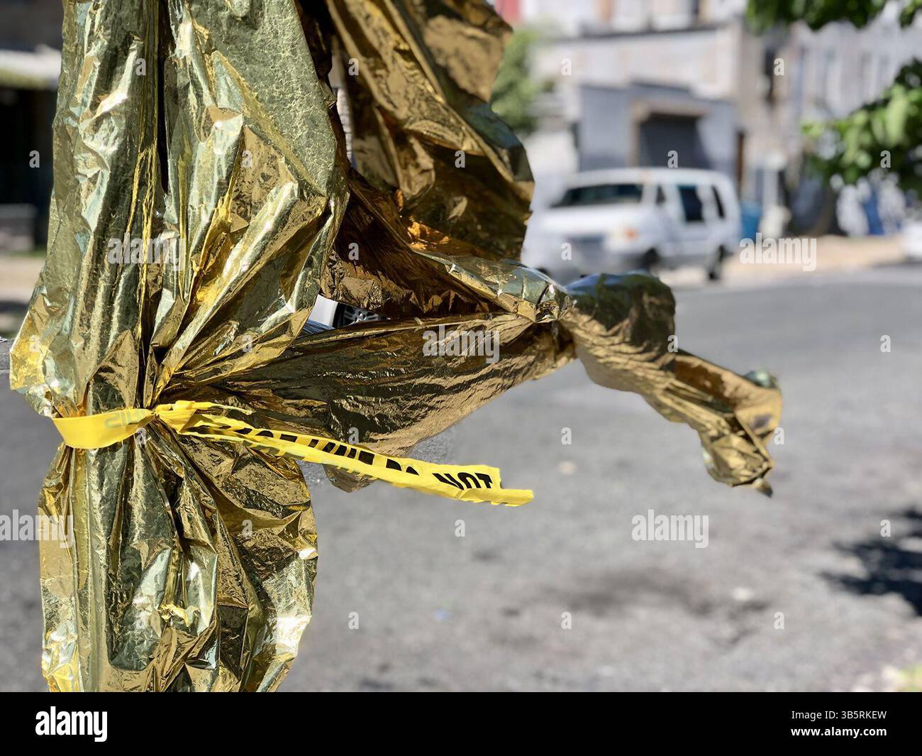 June 20, 2022: Gold balloons and a scrap of crime tape memorialize a ...