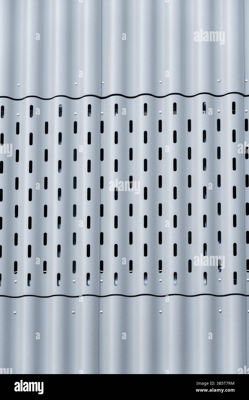 Vertical metallic corrugated sheet with perforated pattern, light gray ...