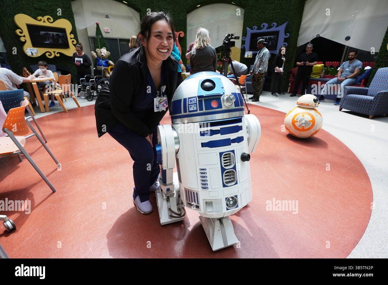 Registered Nurse Diana Bunag poses with a "Star Wars" R2-D2 droid at ...